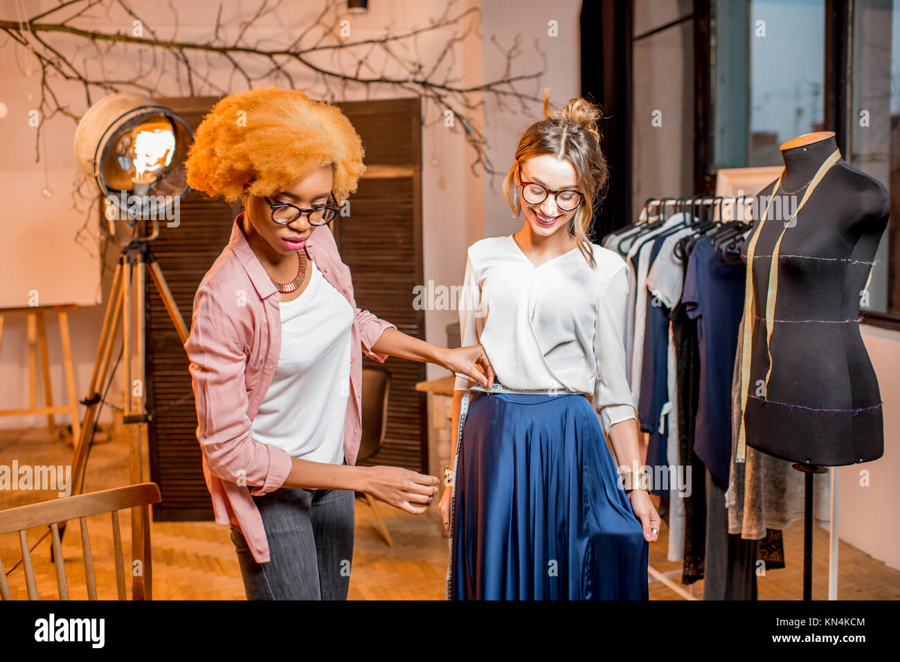 Tailor measuring woman client Stock Photo - Alamy