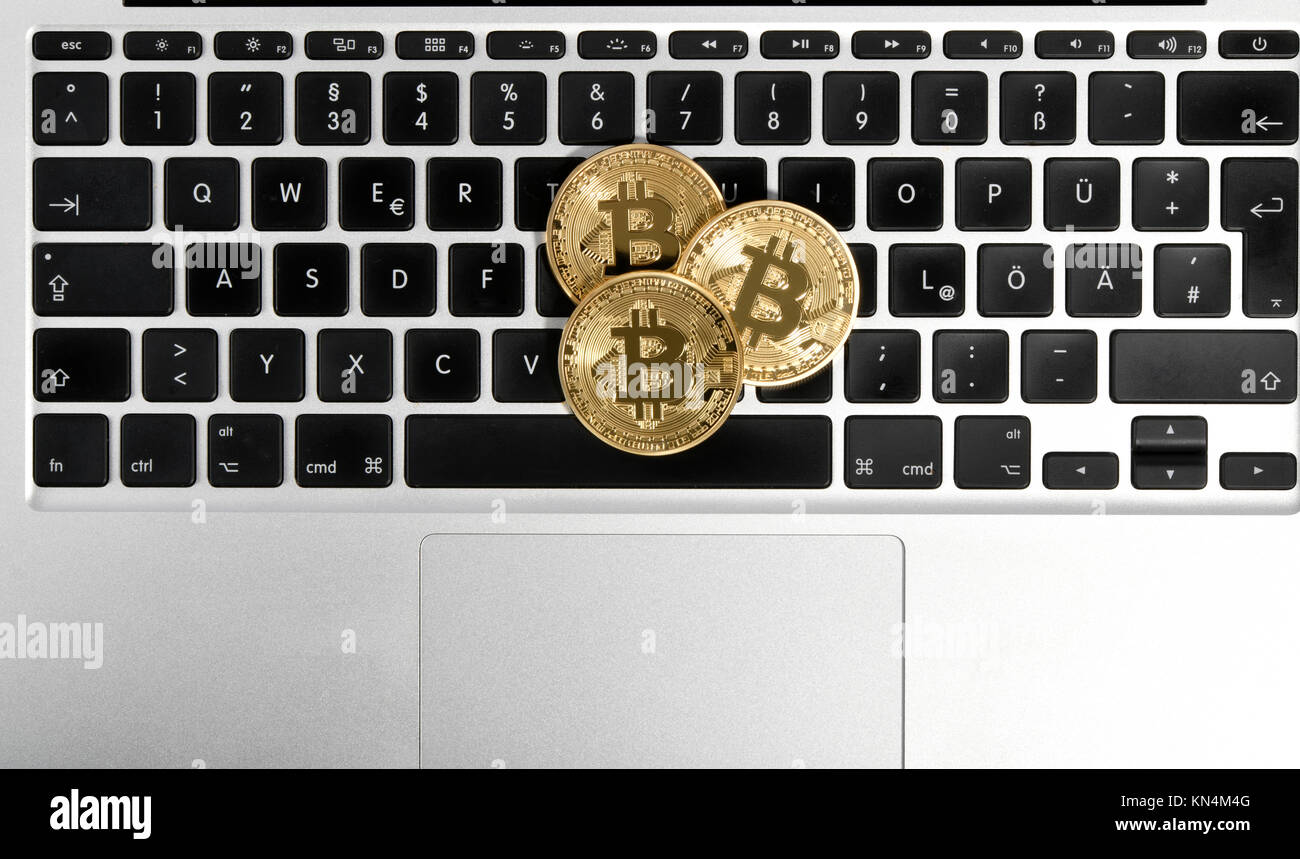 Symbol image digital currency, golden physical coin bitcoin keyboard ...