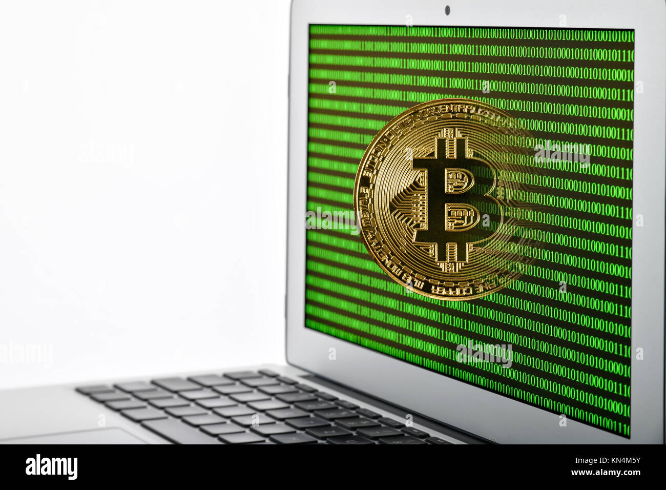 Symbol image cryptocurrency, digital currency, golden physical coin bitcoin laptop with digital ...