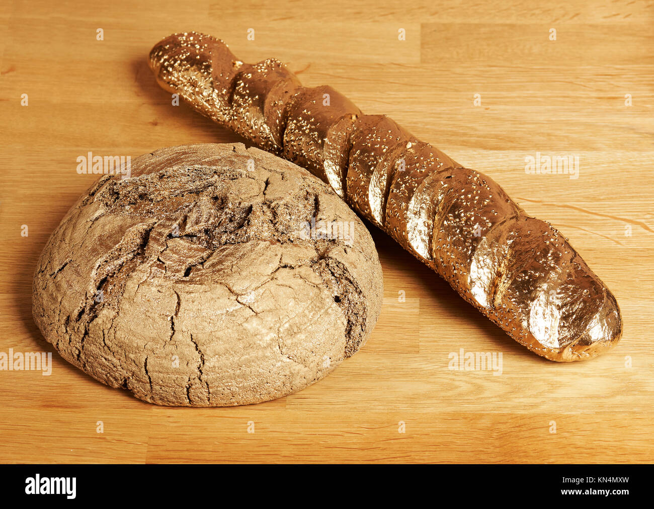 Golden bread on wood table. Gold luxury food theme Stock Photo - Alamy