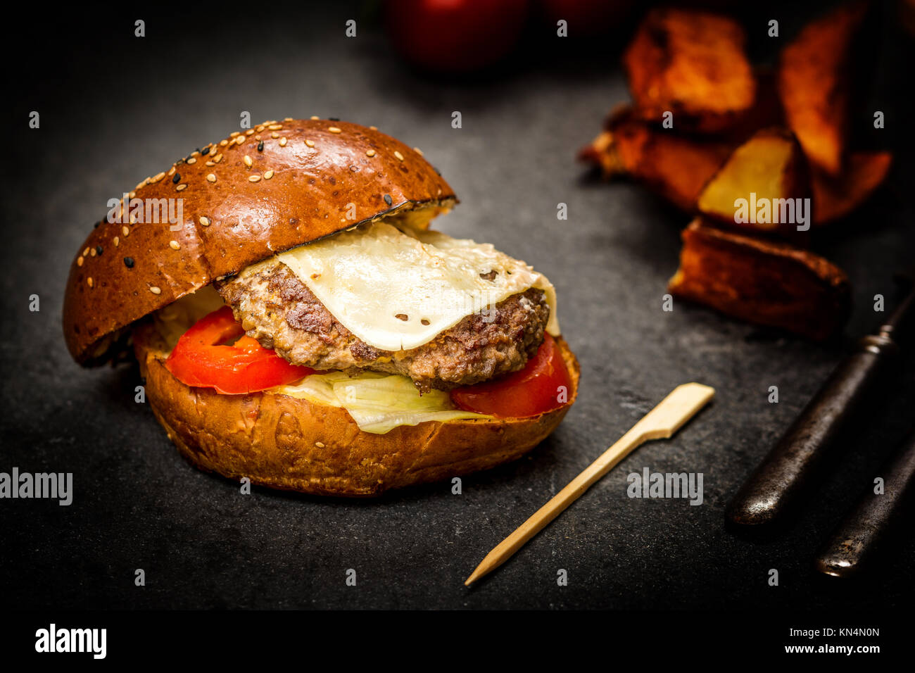 Traditional Cheeseburger with beef meat and fried potato Stock Photo ...