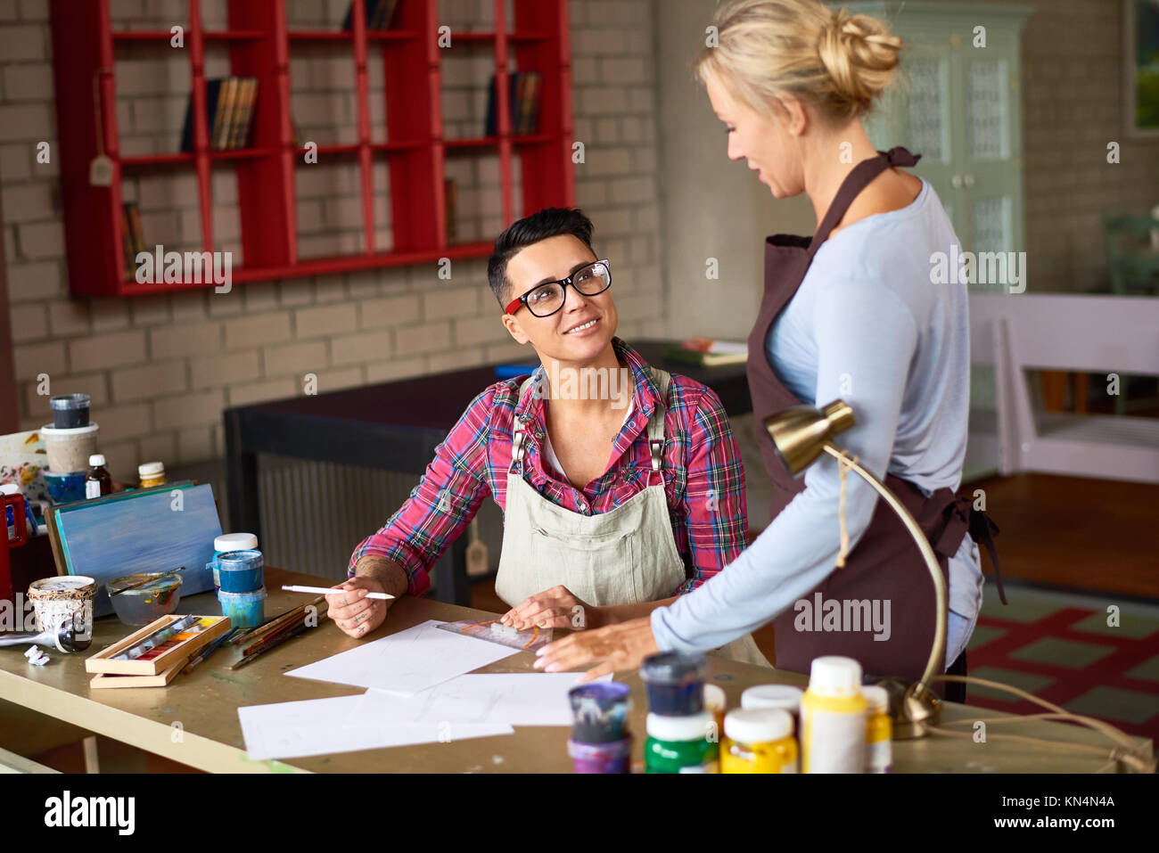 Two Creative Artists Working in Studio Stock Photo - Alamy