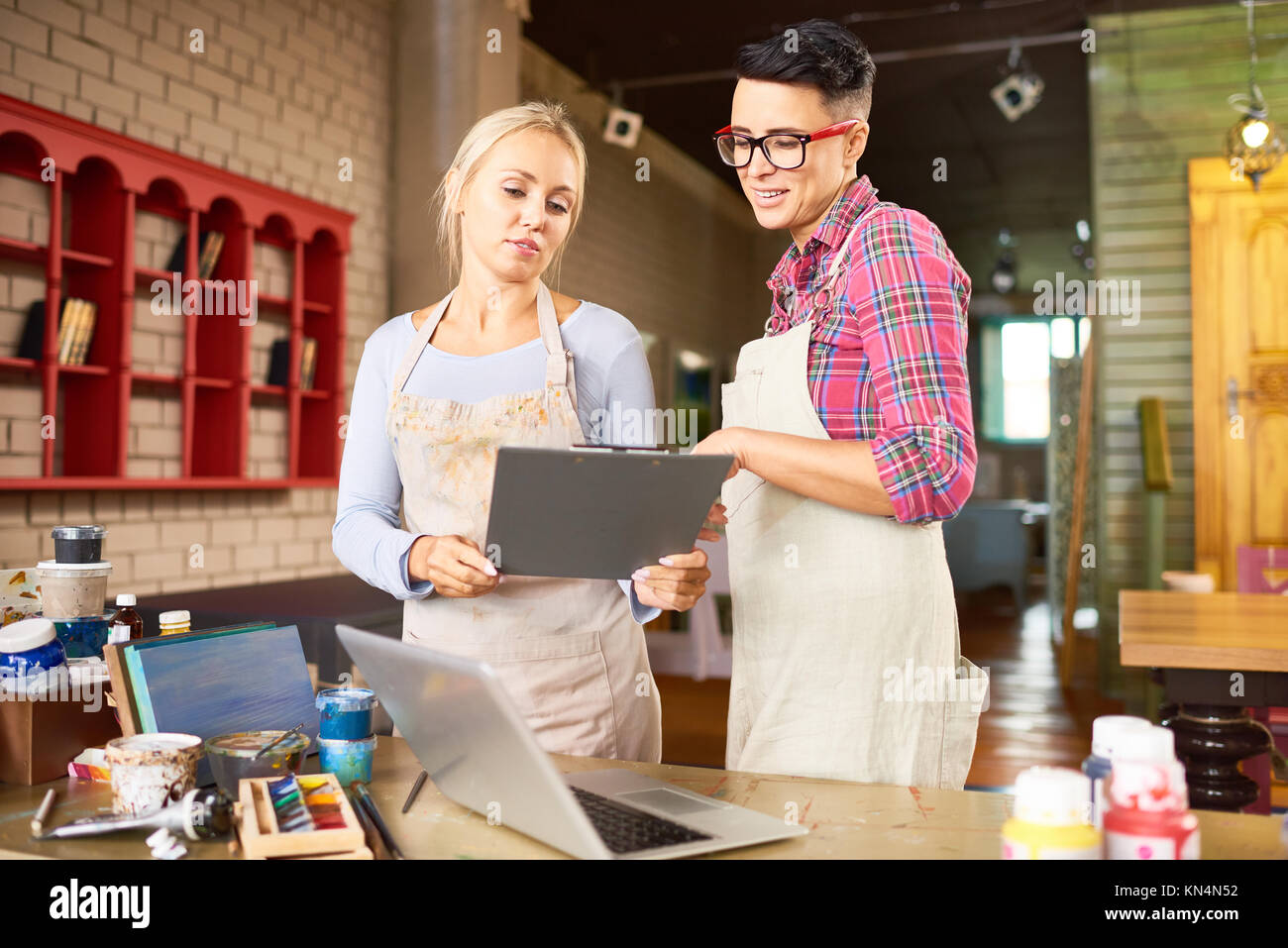 Two Artists Planning Project in Studio Stock Photo - Alamy