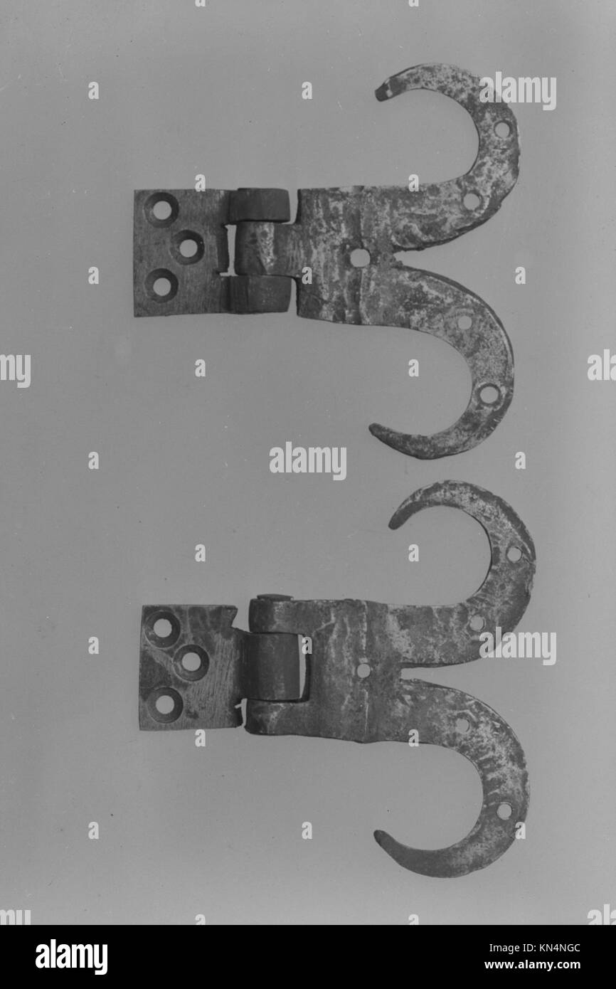 This hinge is a functional and decorative object, crafted from metal ...