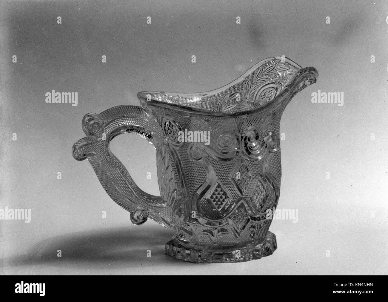 This American creamer, dated circa 1830–1840, is made of lacy pressed ...