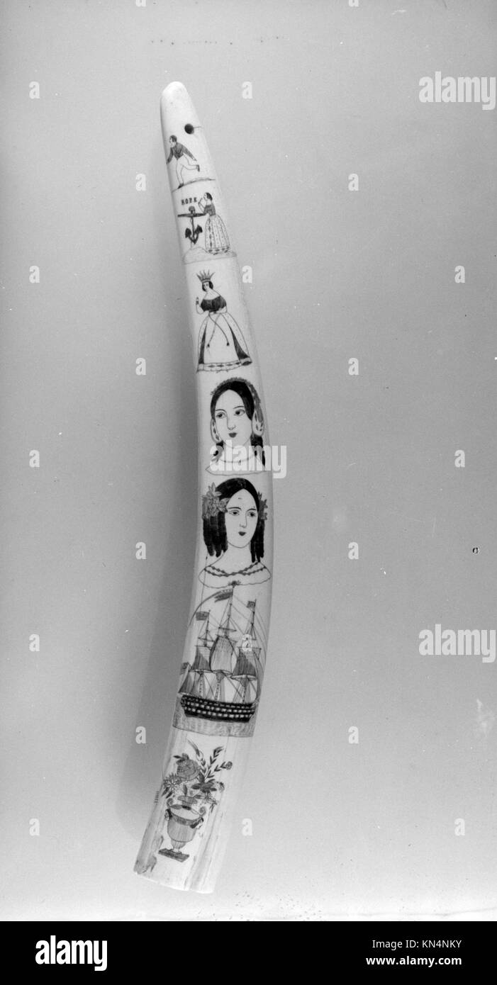 This is a decorated walrus tusk, featuring intricate carvings and ...