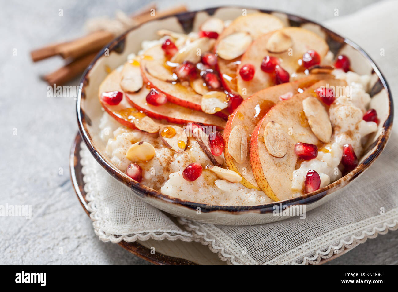Coconut rice with pomegranate, pear and almond slices Stock Photo - Alamy