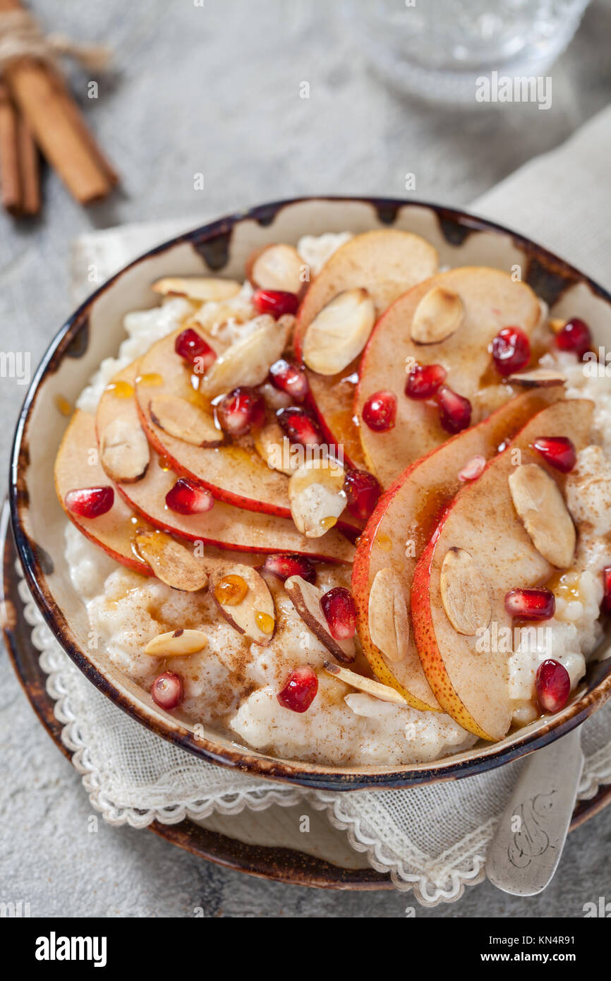 Coconut rice with pomegranate, pear and almond slices Stock Photo - Alamy