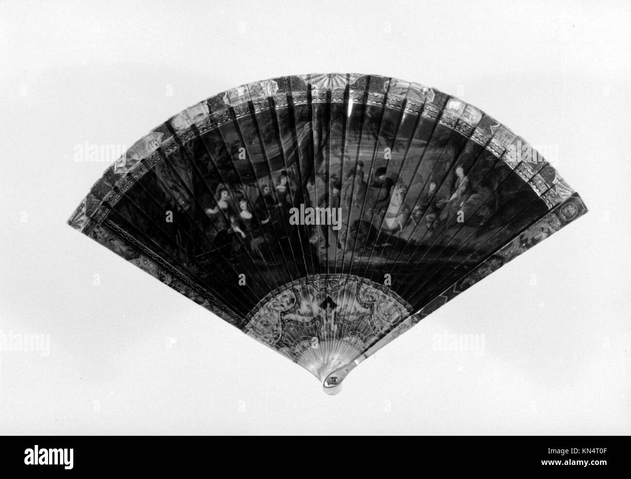 This fan, crafted with intricate design, was likely used as both a ...
