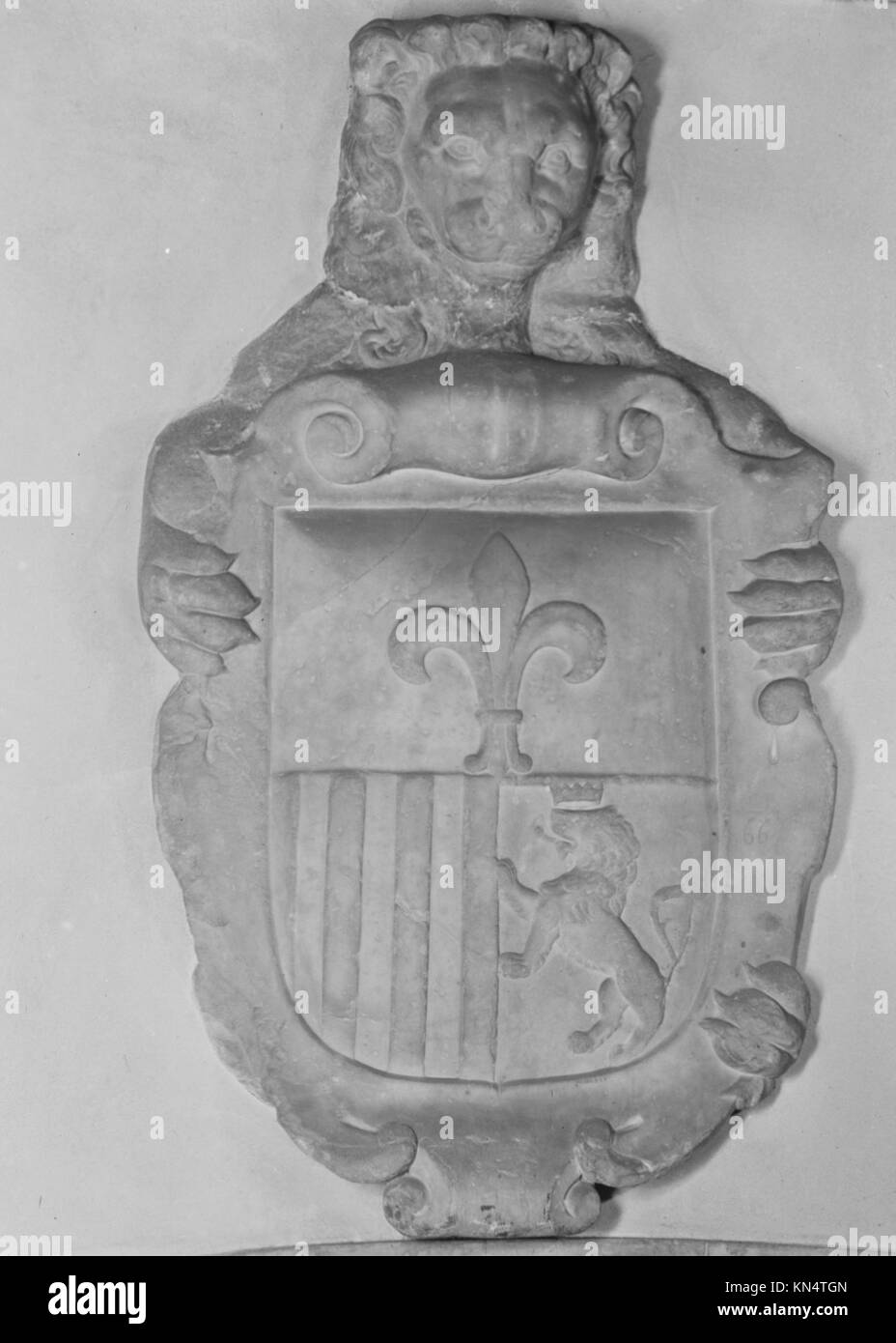 This armorial shield features a coat of arms, showcasing the heraldic ...