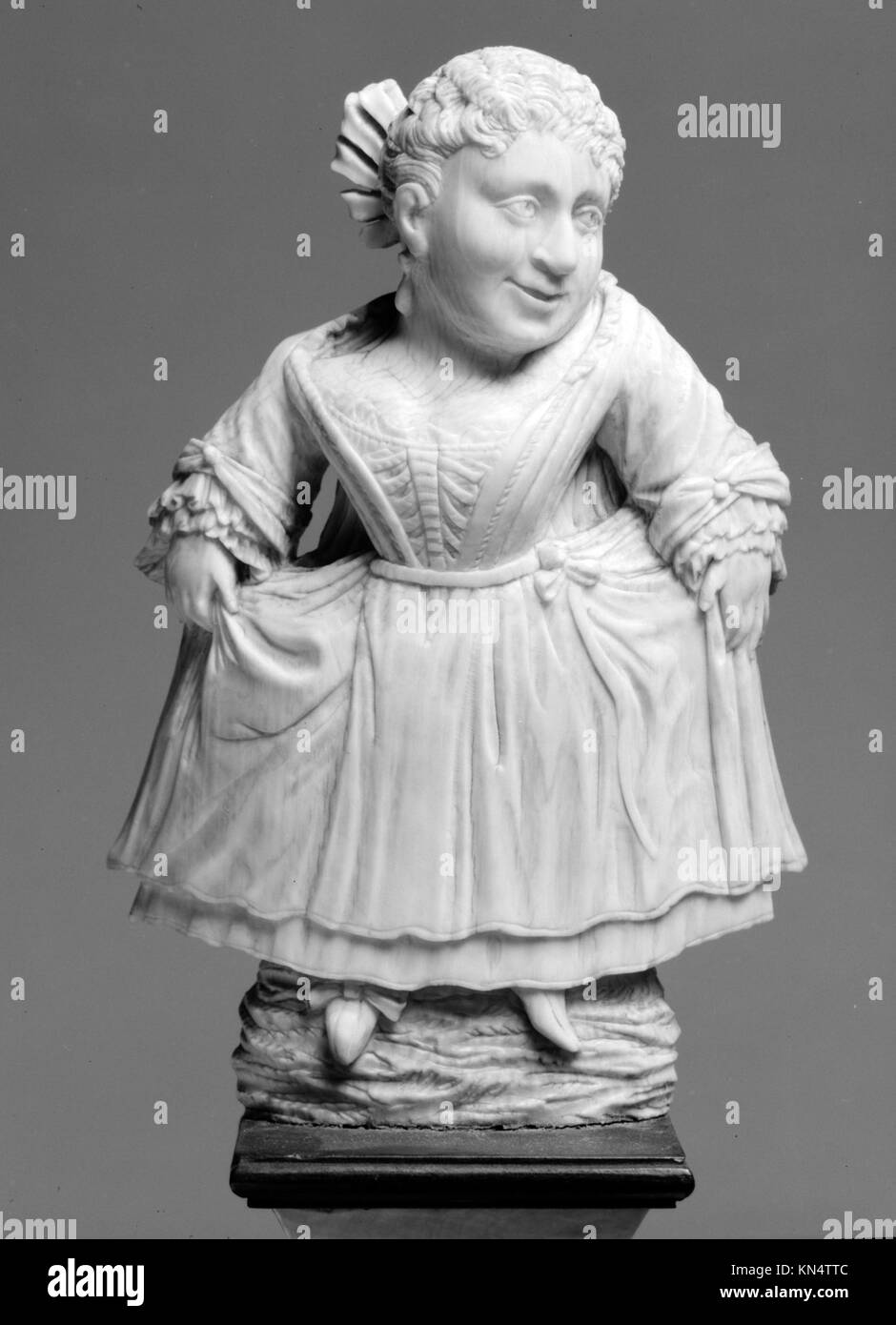 This figurine, 'Female Dancing Dwarf,' depicts a lively and playful ...