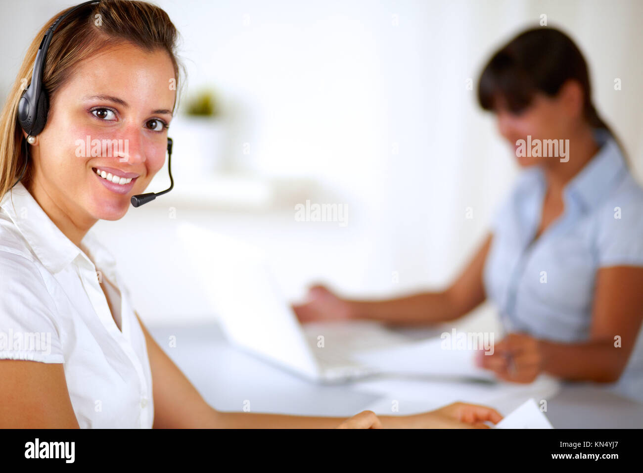 Young friendly receptionist wearing headphone at call center Stock ...