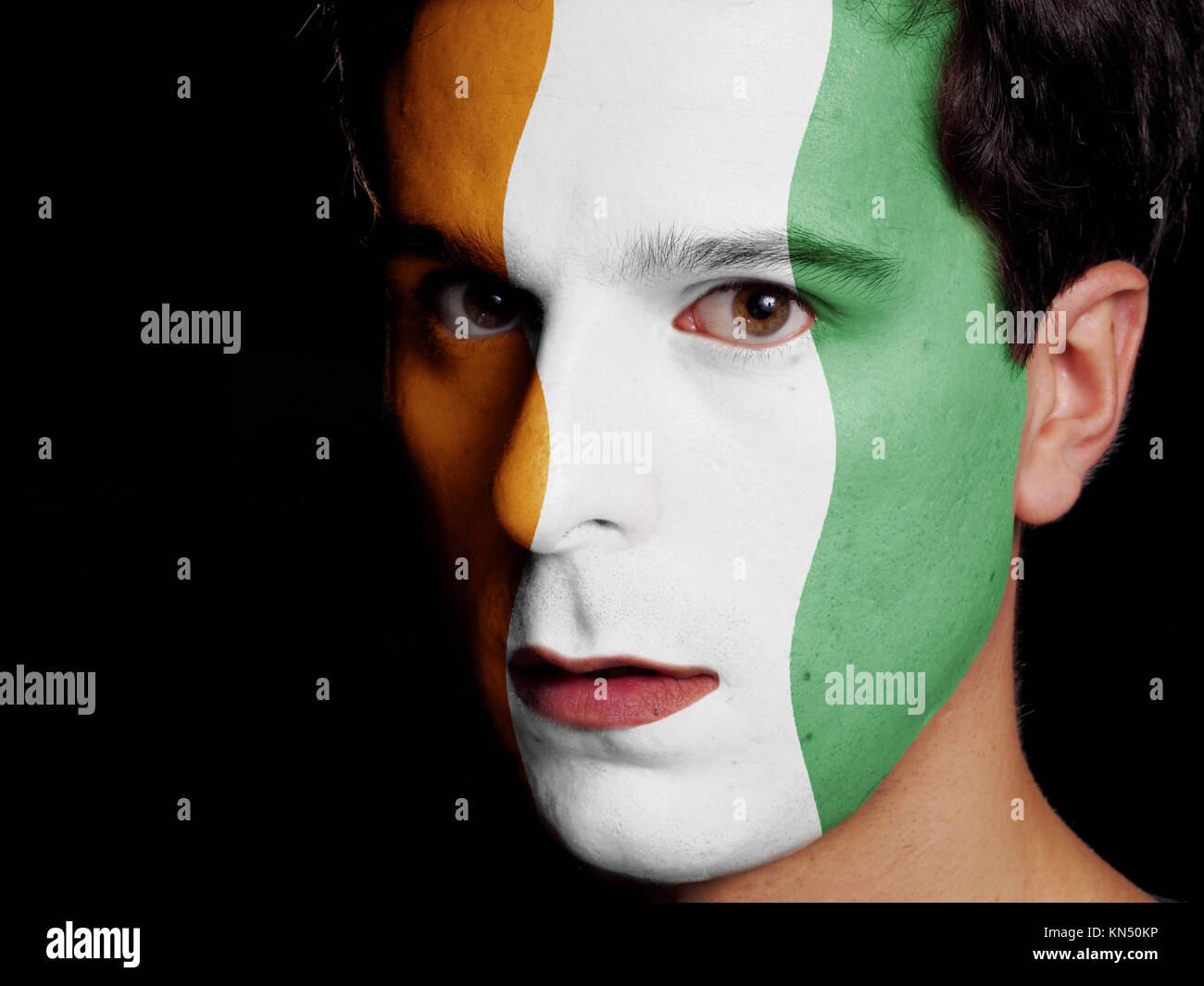 Flag of Ivory Coast Painted on a Face of a Young Man Stock Photo - Alamy