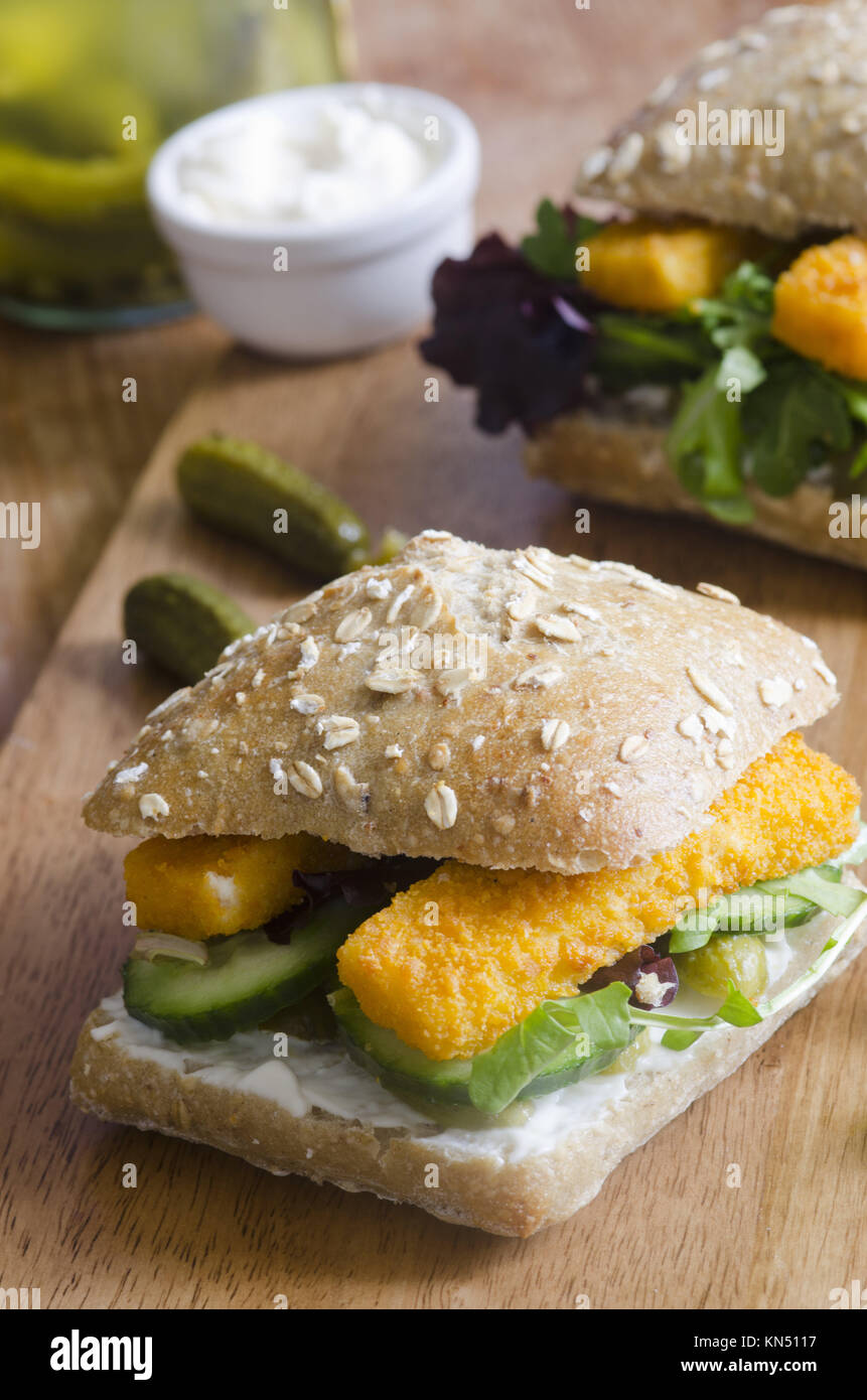 Ciabatta filled with golden fish fingers and salad Stock Photo - Alamy