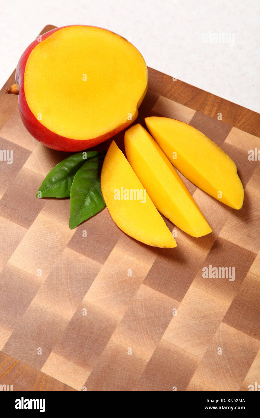 Mango fruit on chopping board hi-res stock photography and images - Alamy