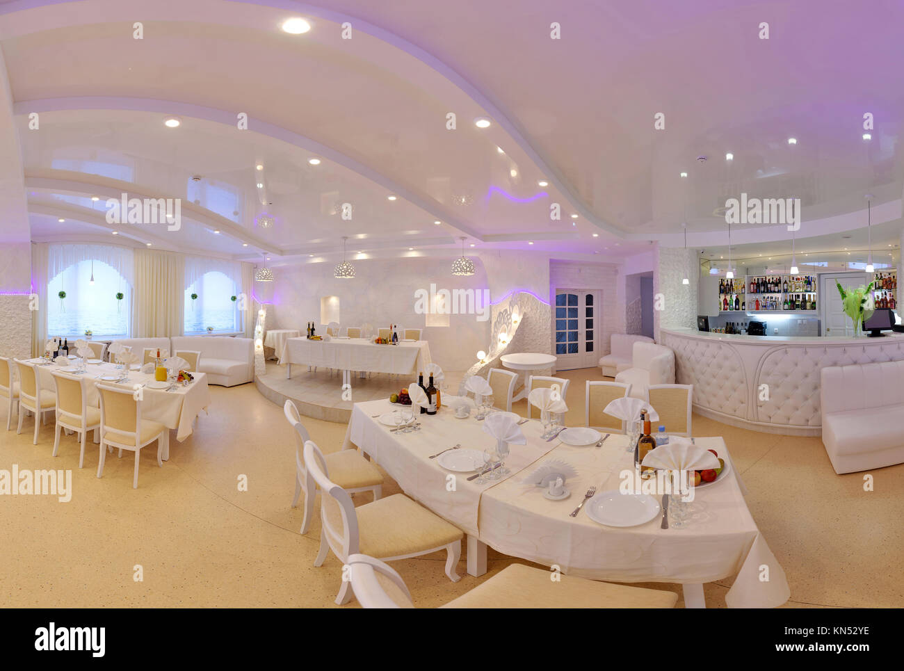 panorama of big light cafe with a set of tables, a bar counter and ...