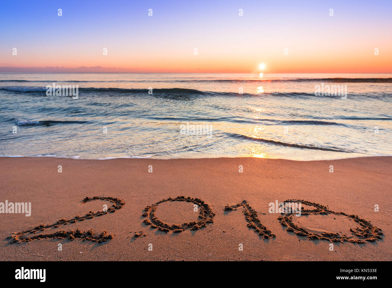 Number 2018 written on seashore sand at sunrise Stock Photo - Alamy