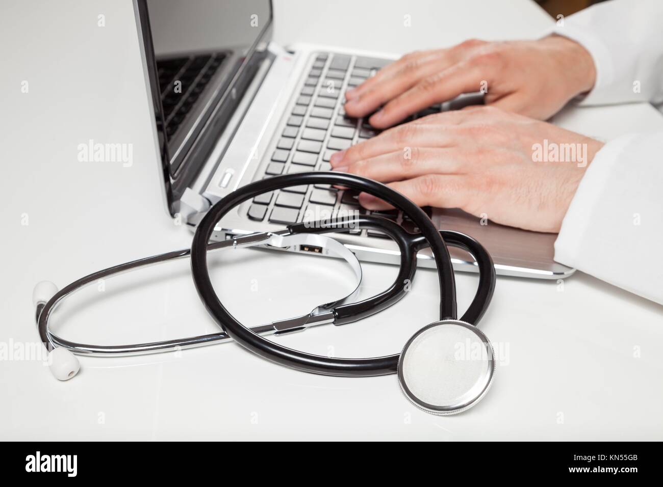 Doctor typing computer hi-res stock photography and images - Alamy