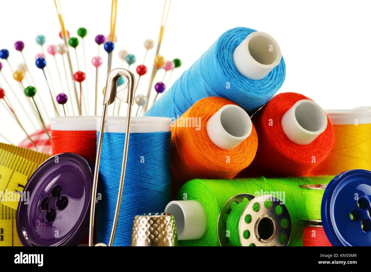Composition with tailor threads over white background Stock Photo - Alamy