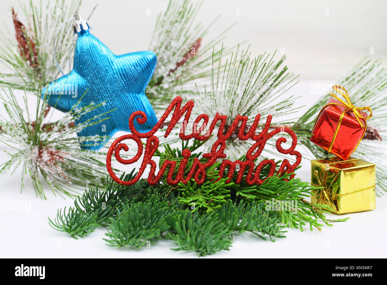 Merry Christmas written with letters covered in red glitter, bauble in ...