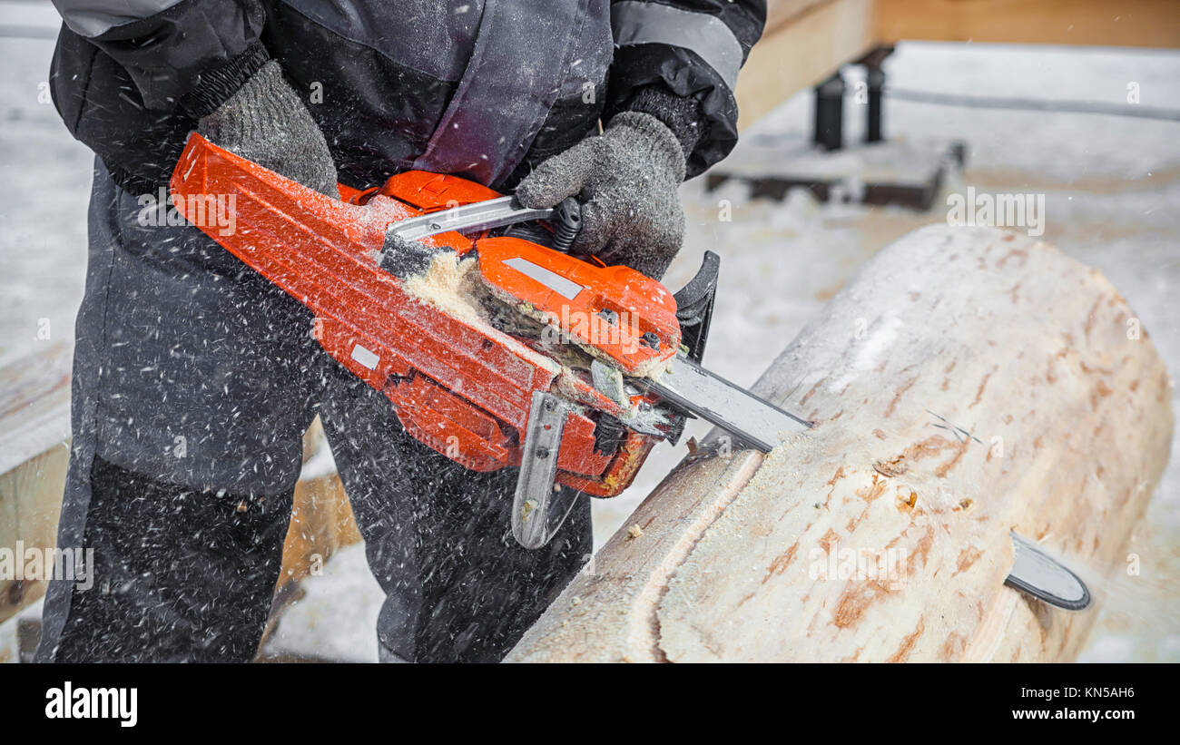 Close-up of a male construction worker and lumberjack in a hat and warm ...