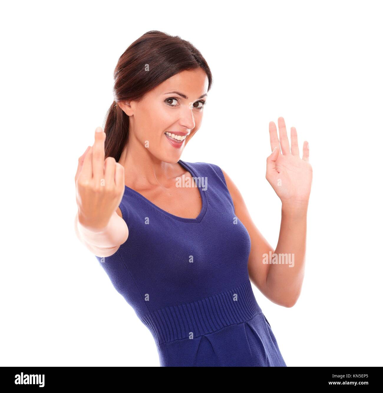 Lovely lady making a wish and luck sign while looking at you in white ...