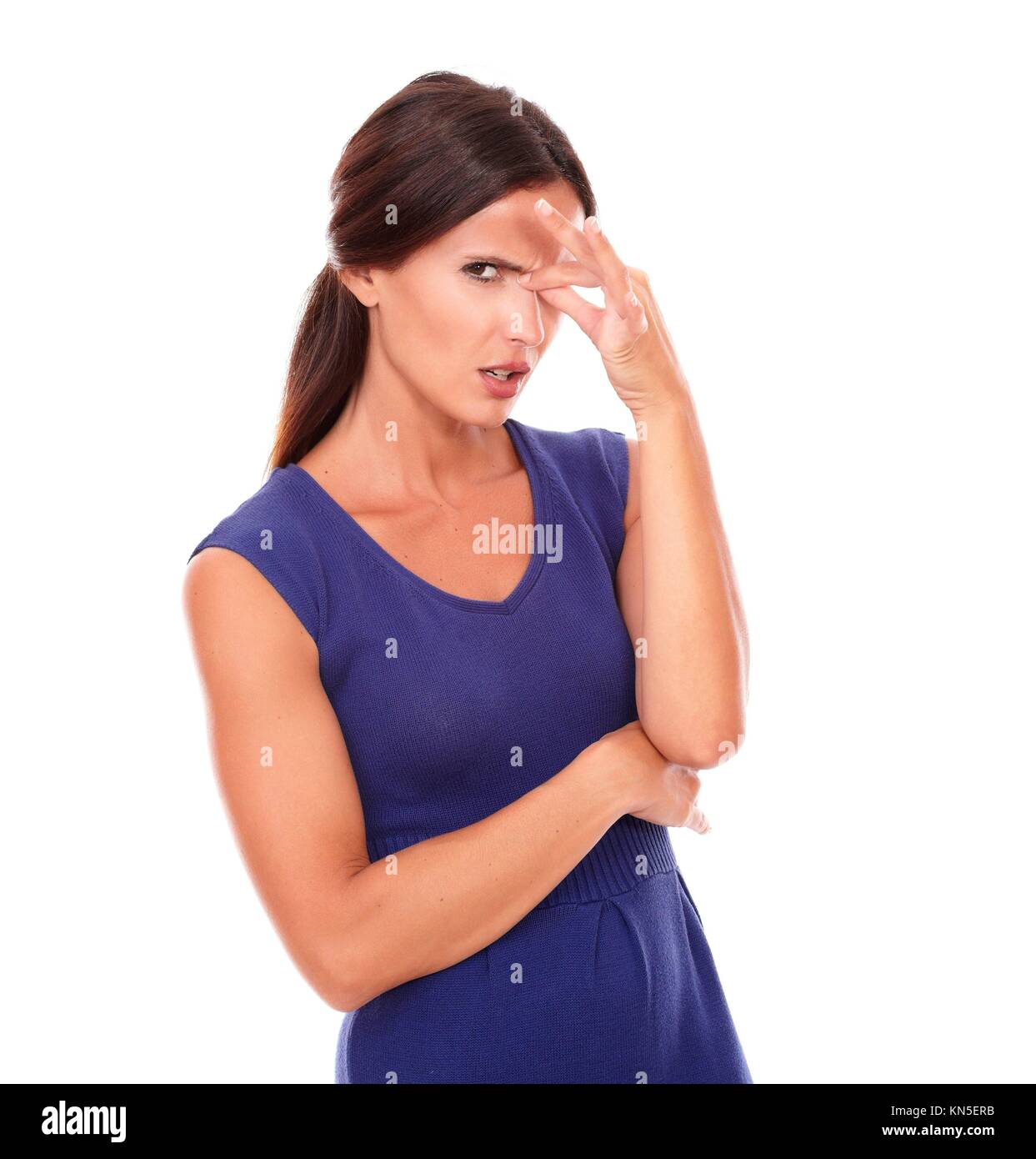 Young brunette lady suffering from headache while looking at you and ...