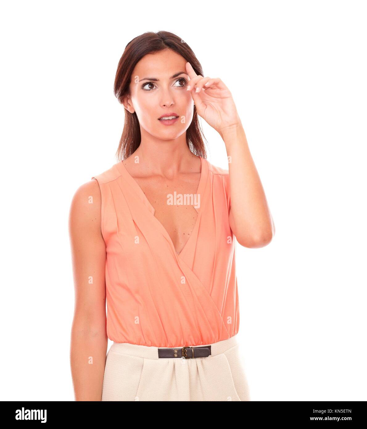 Beautiful lady looking up and wondering about a question while standing ...