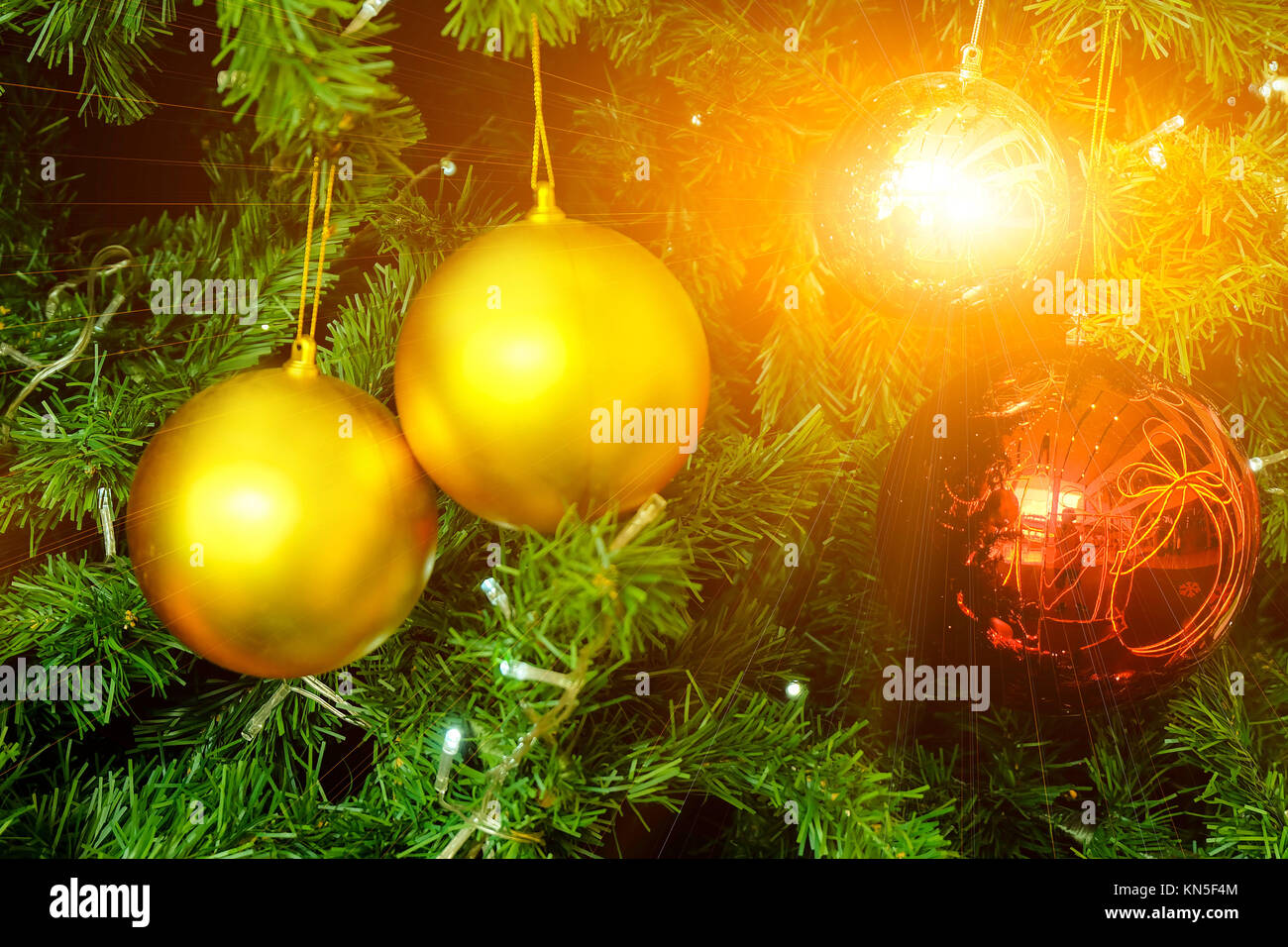 fir tree in chirstmas festivals with flares light and balls background ...