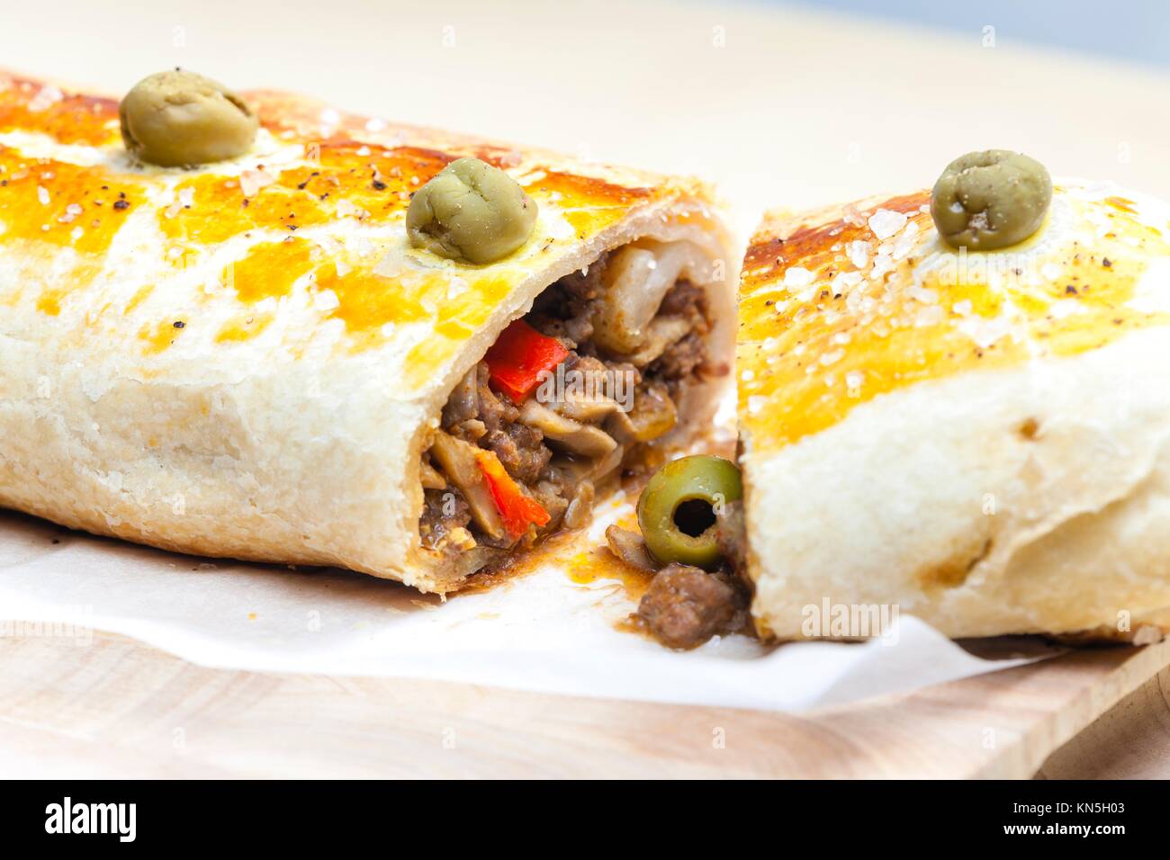 puff roly-poly filled with minced meat and green olives Stock Photo - Alamy