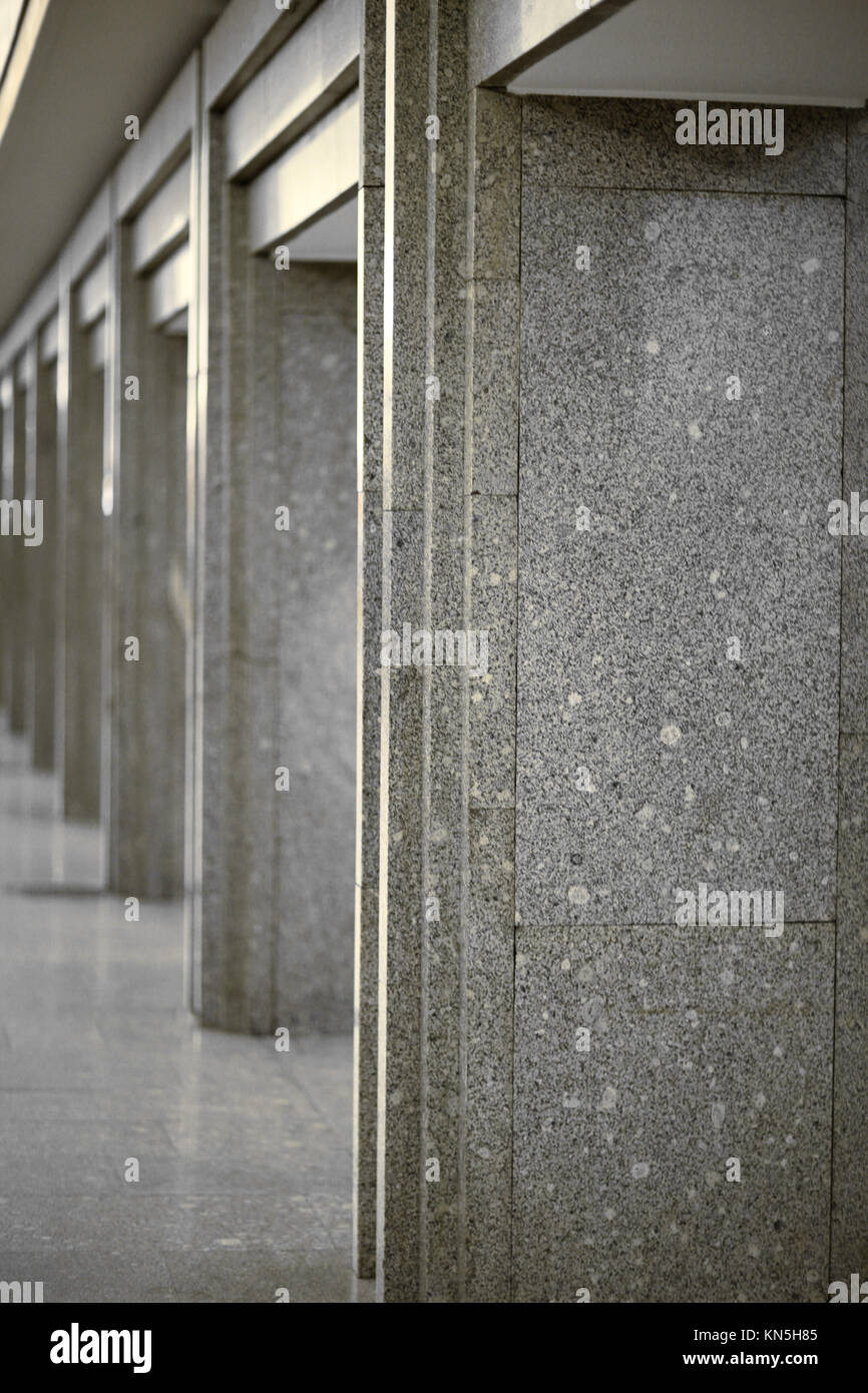 Many of columns coated with gray granite Stock Photo - Alamy