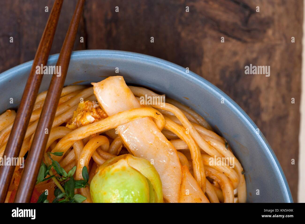 hand pulled stretched Chinese ramen noodles on a bowl with chopstick ...