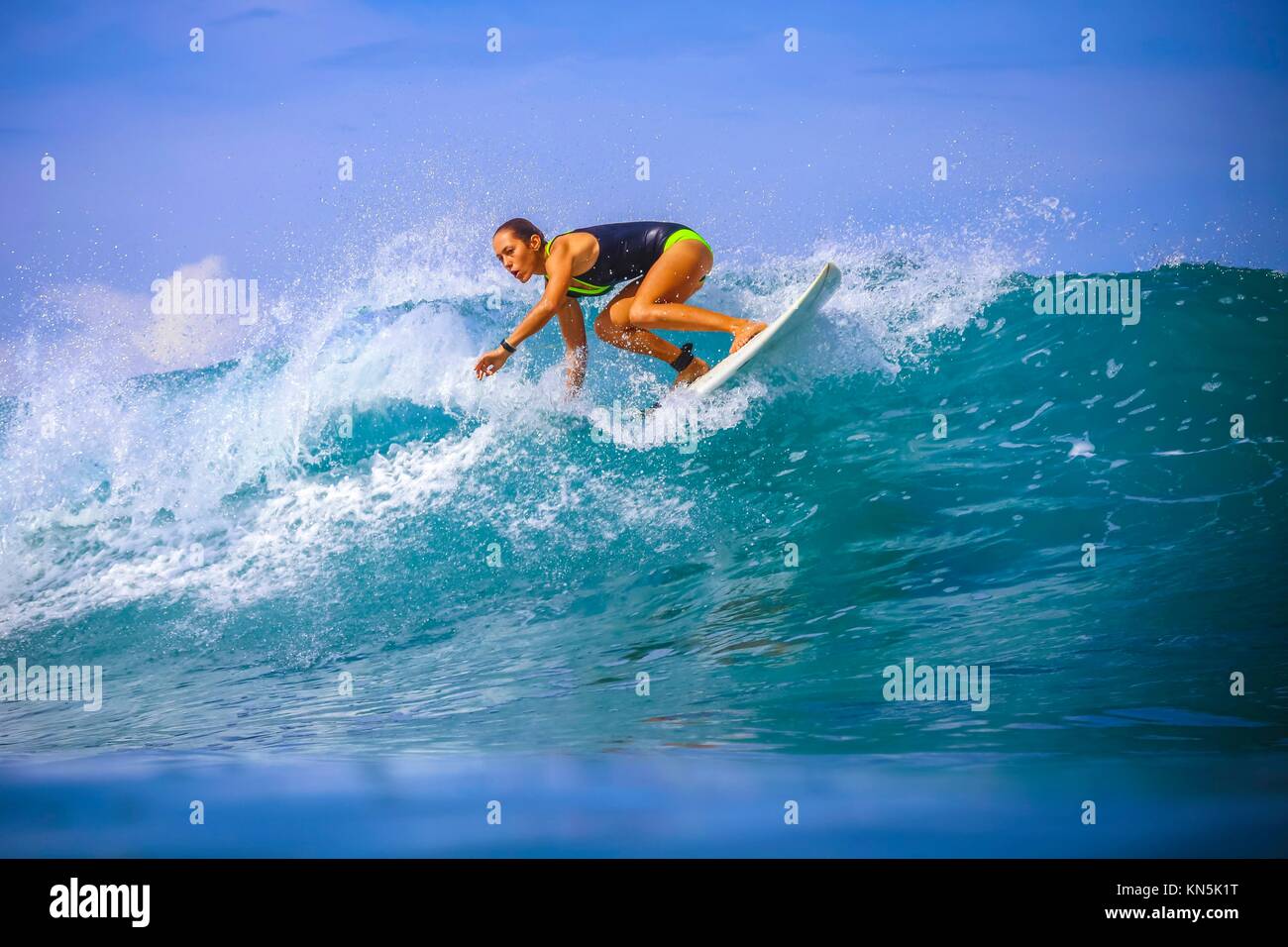 Surfer girl on Amazing Blue Wave, Bali island Stock Photo - Alamy