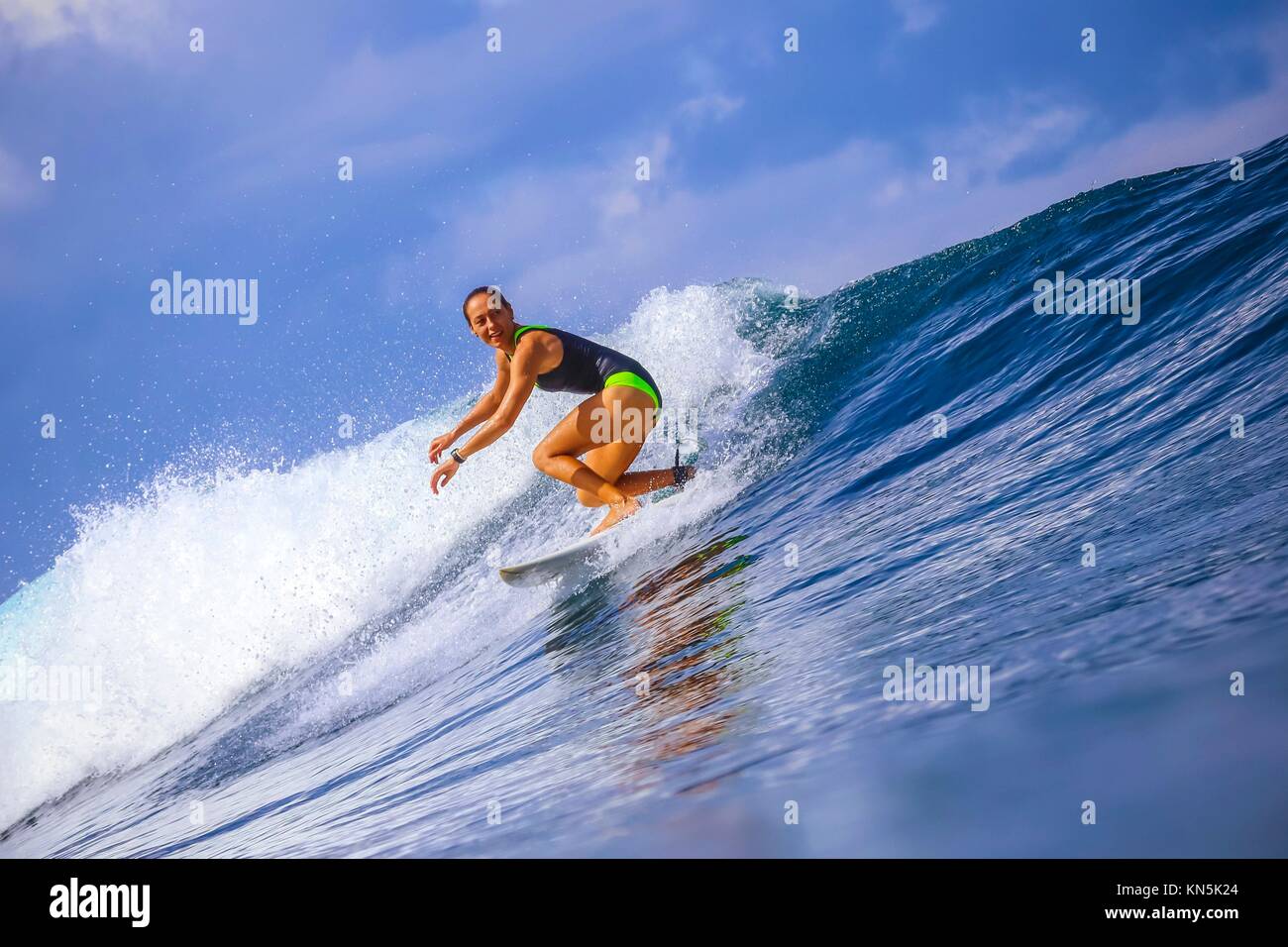 Surfer girl on wave indonesia hi-res stock photography and images - Alamy