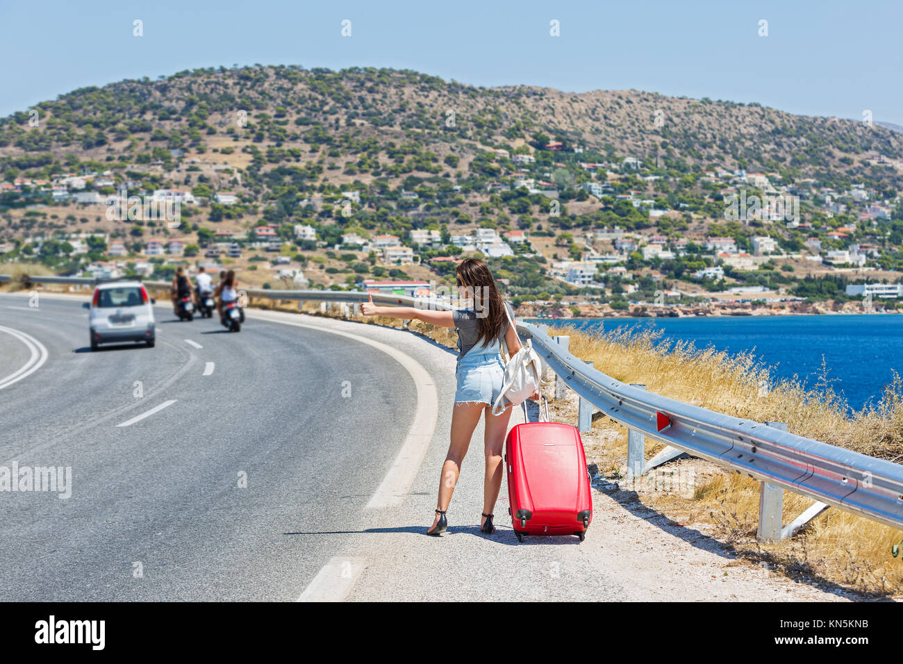 Car passing by woman hi-res stock photography and images - Alamy