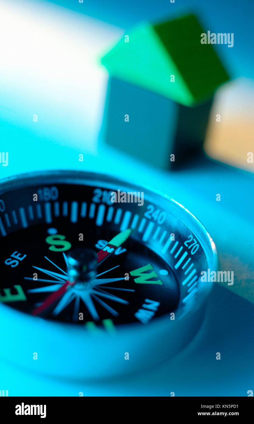 Compass and toy house Stock Photo - Alamy
