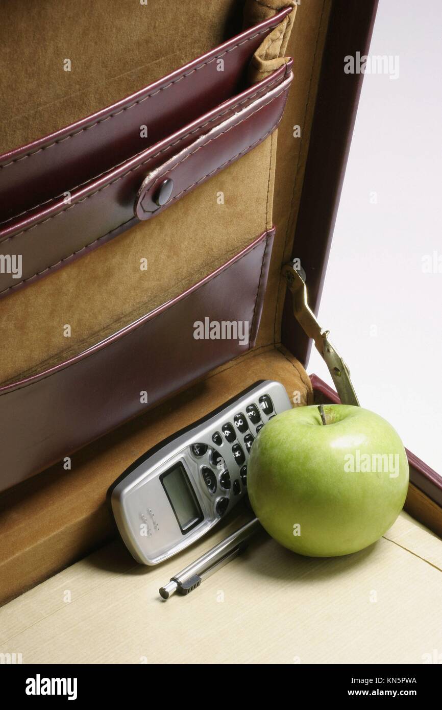 Apple and mobile phone in briefcase Stock Photo - Alamy