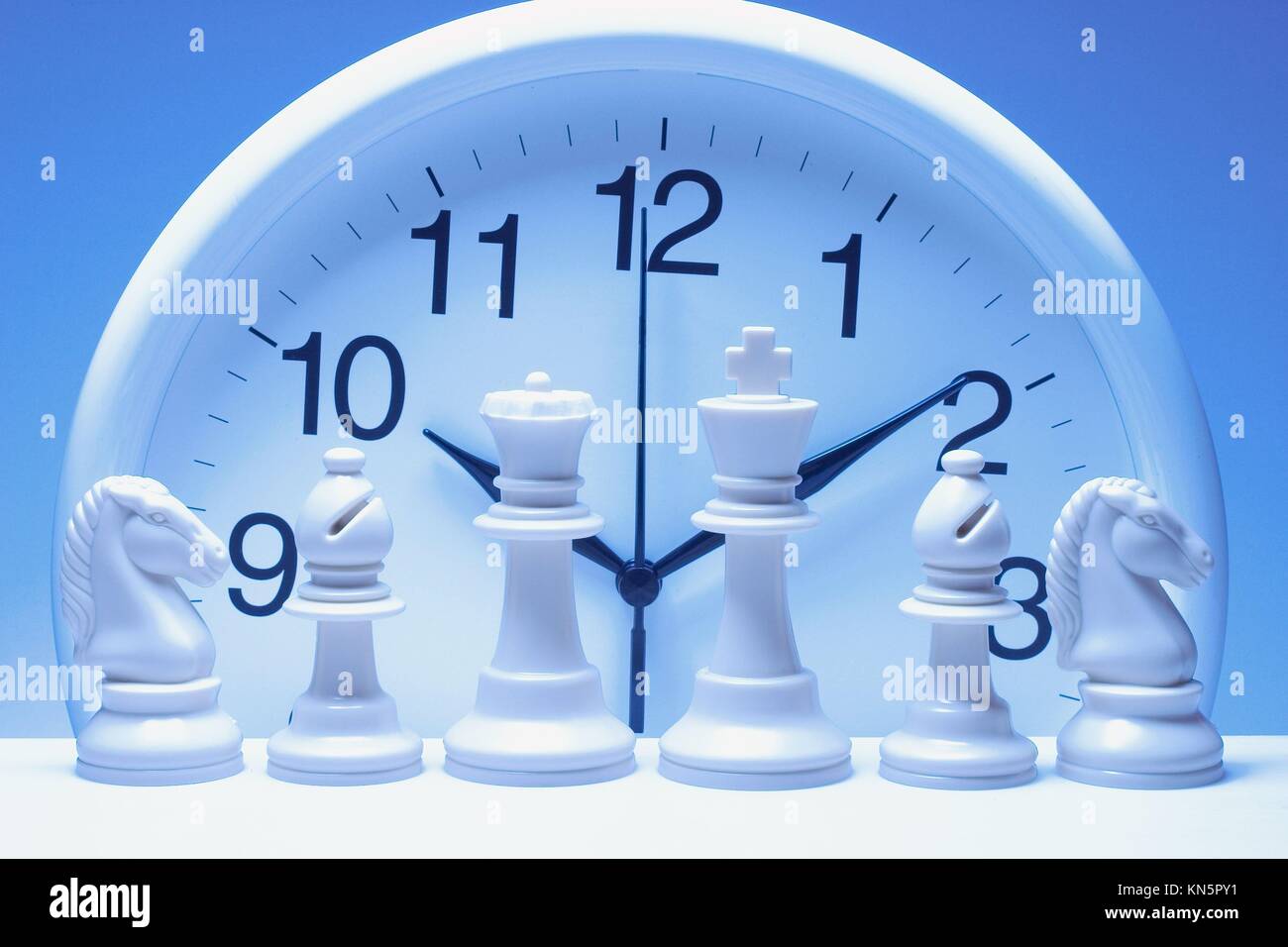Chess pieces and clock Stock Photo - Alamy