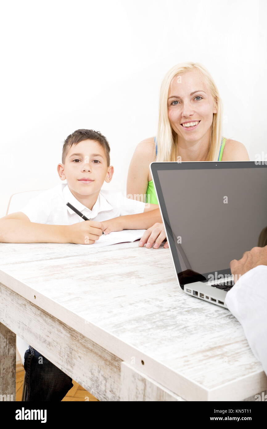 A mother helping his son with his homework Stock Photo - Alamy