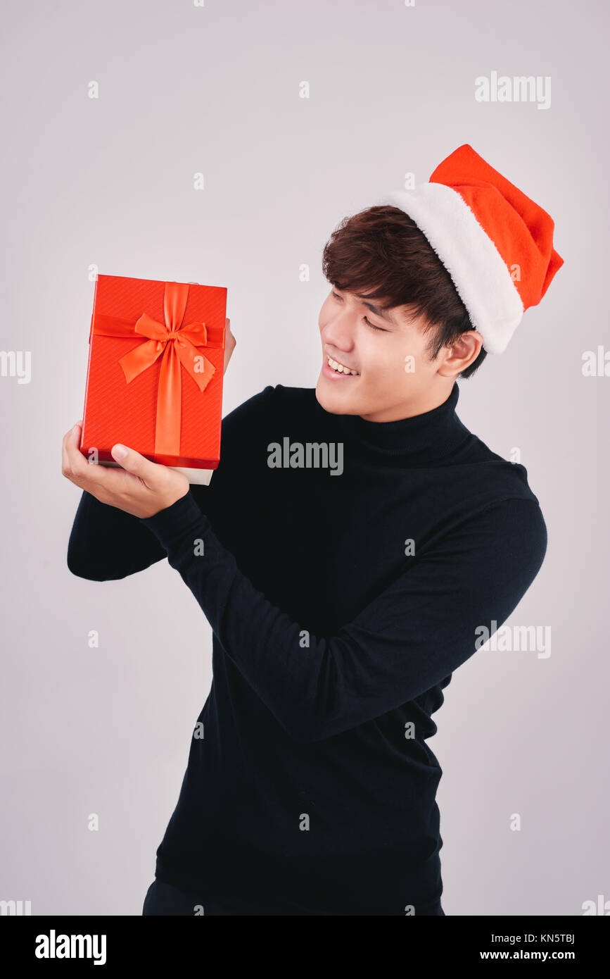 Asian man offering a christmas gift isolated on white background Stock ...