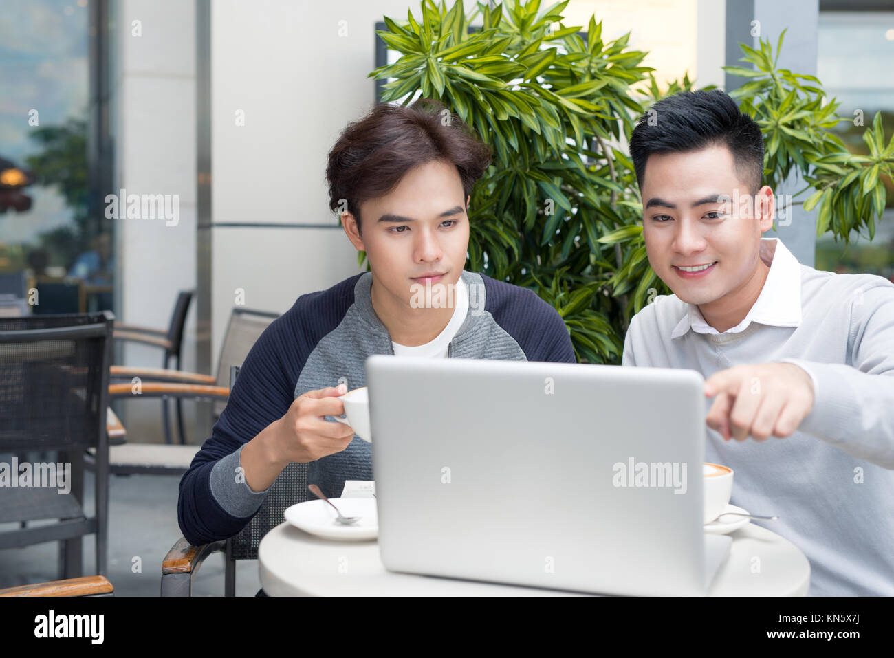 Handsome Asian business colleagues or college students work together ...