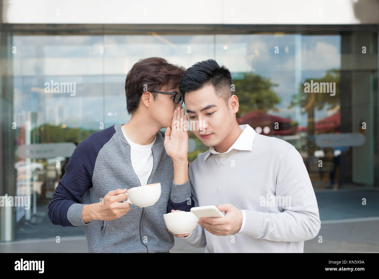 Ear whisper men hi-res stock photography and images - Alamy