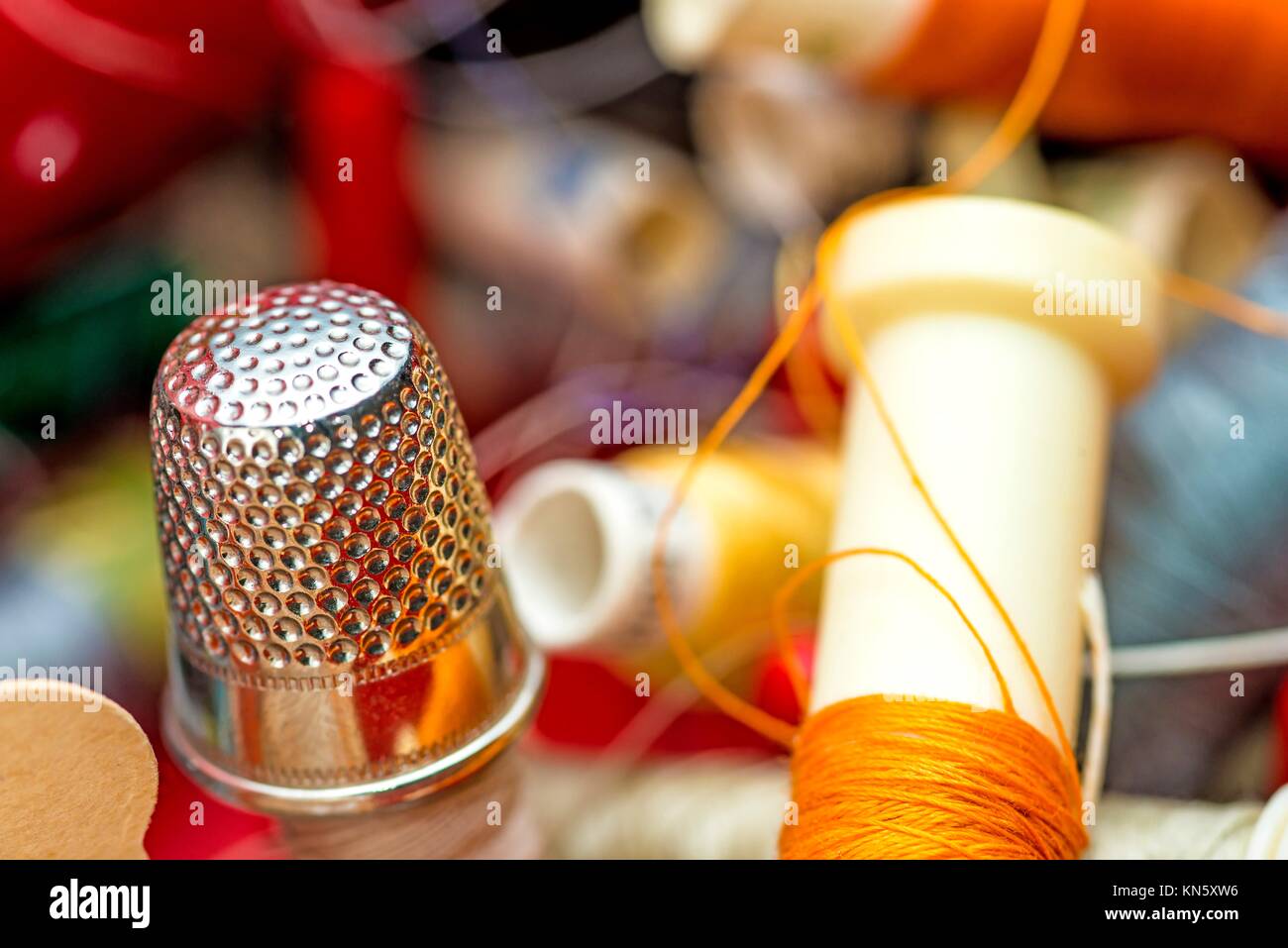 Thimble with thread Stock Photo - Alamy