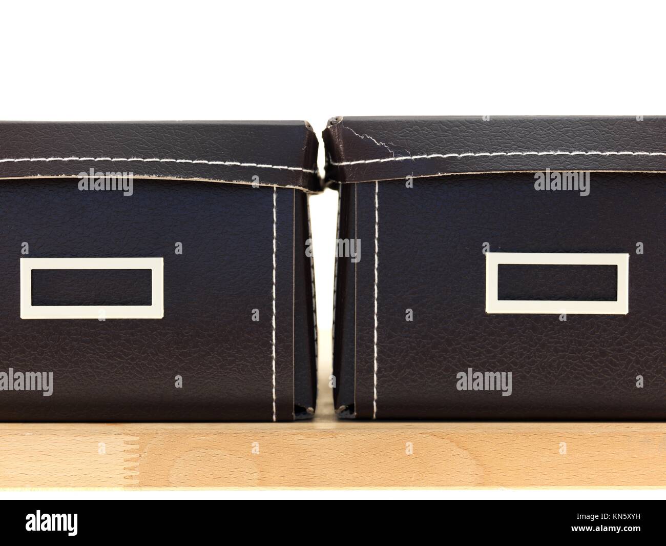 Storage boxes isolated on a wooden shelf Stock Photo - Alamy
