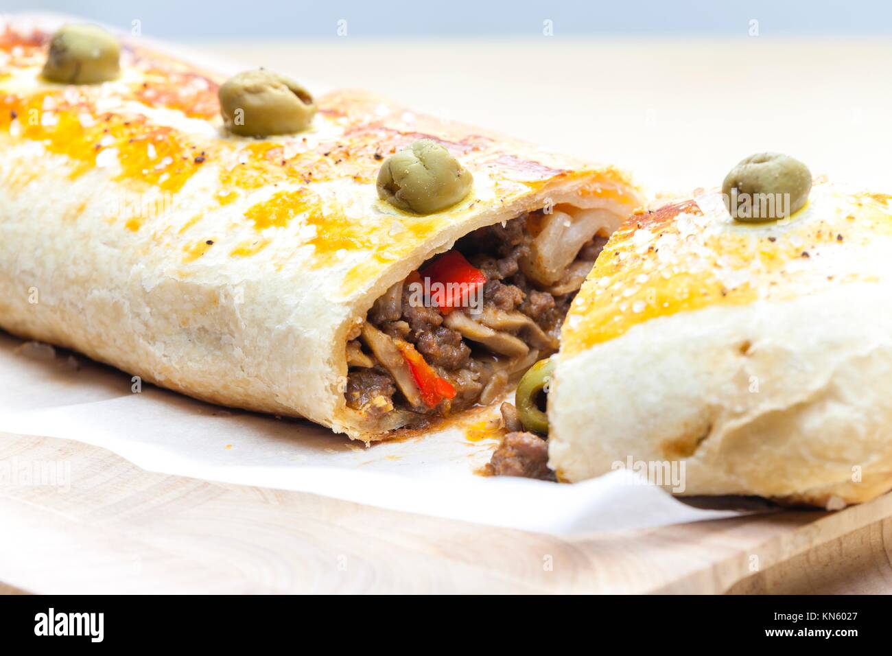 puff roly-poly filled with minced meat and green olives Stock Photo - Alamy
