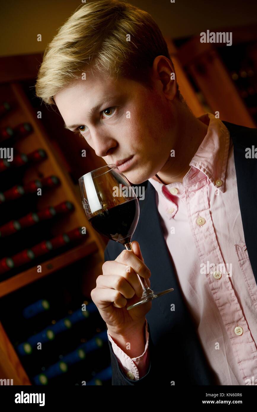Wine Waiter tasting wine in a cellar Stock Photo - Alamy
