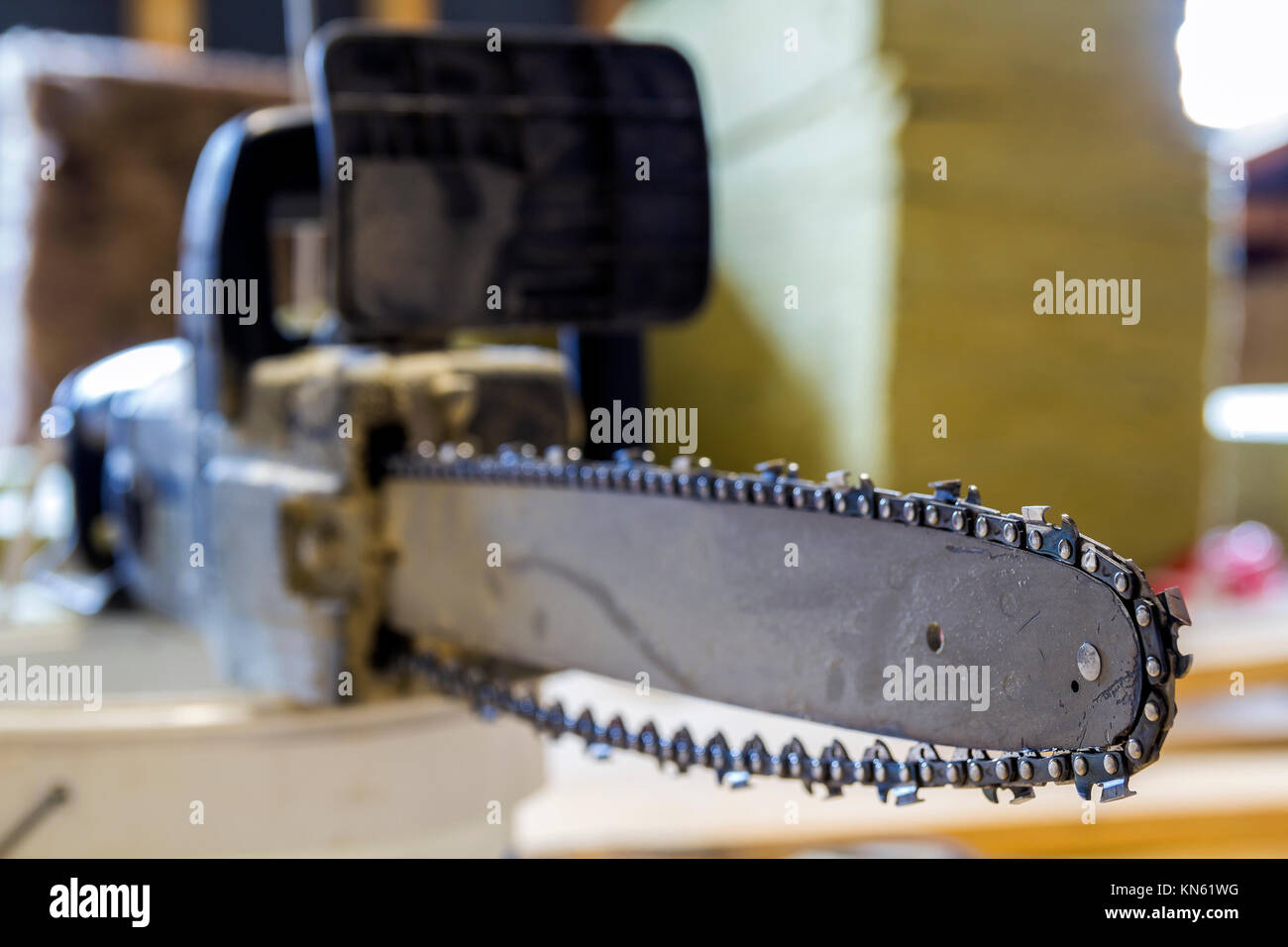 Closeup view of a chainsaw bar and cutting chain at construction site ...
