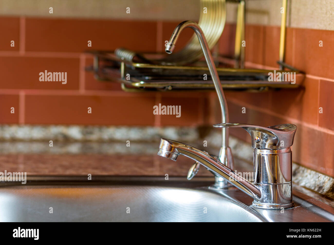 New shiny metal water faucet in modern kitchen Stock Photo - Alamy