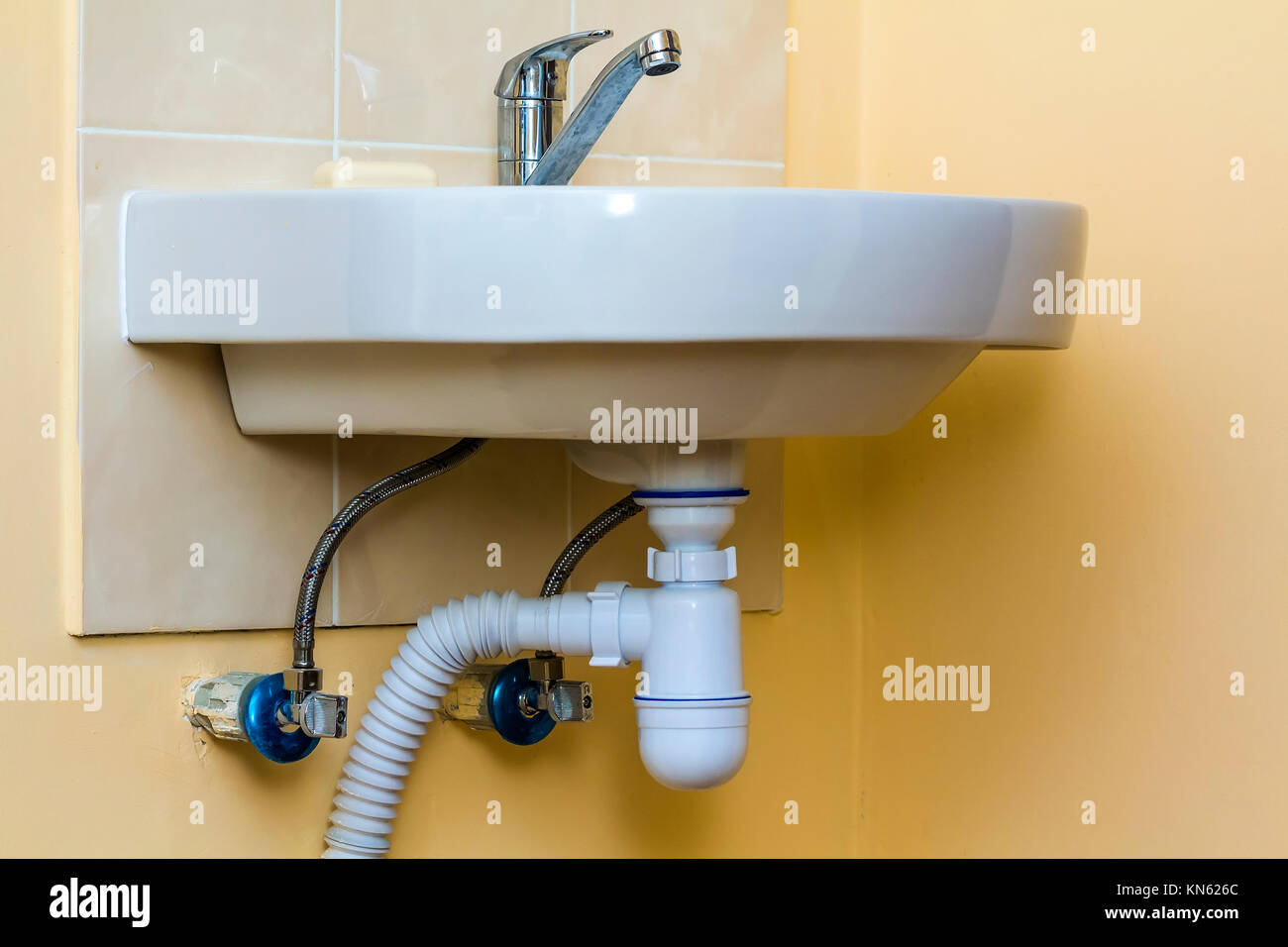 Sewer drain pipes under the kitchen sink.Plumbing fixture and faucets ...