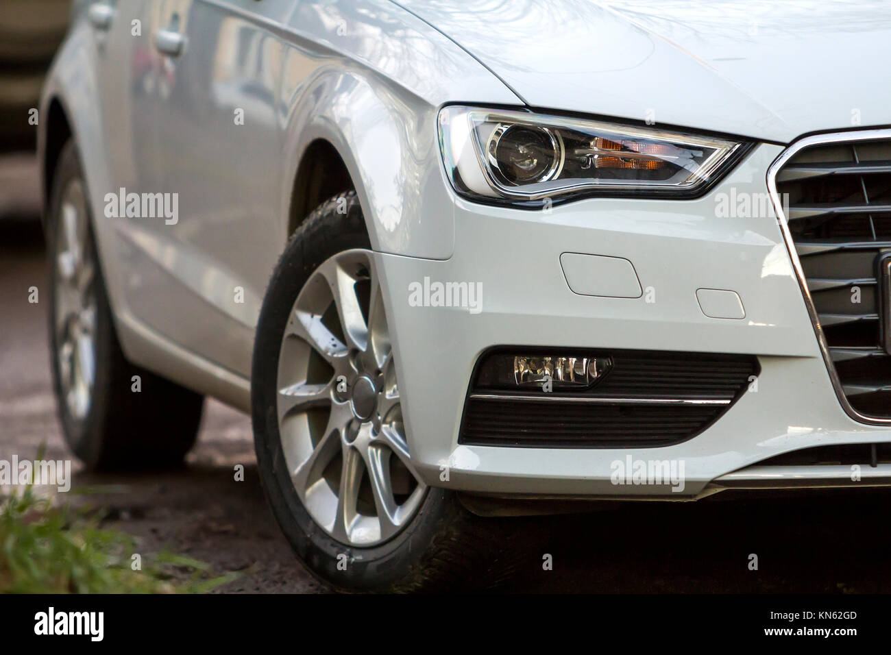 Close-up view of a new modern car parked on the side of the street ...